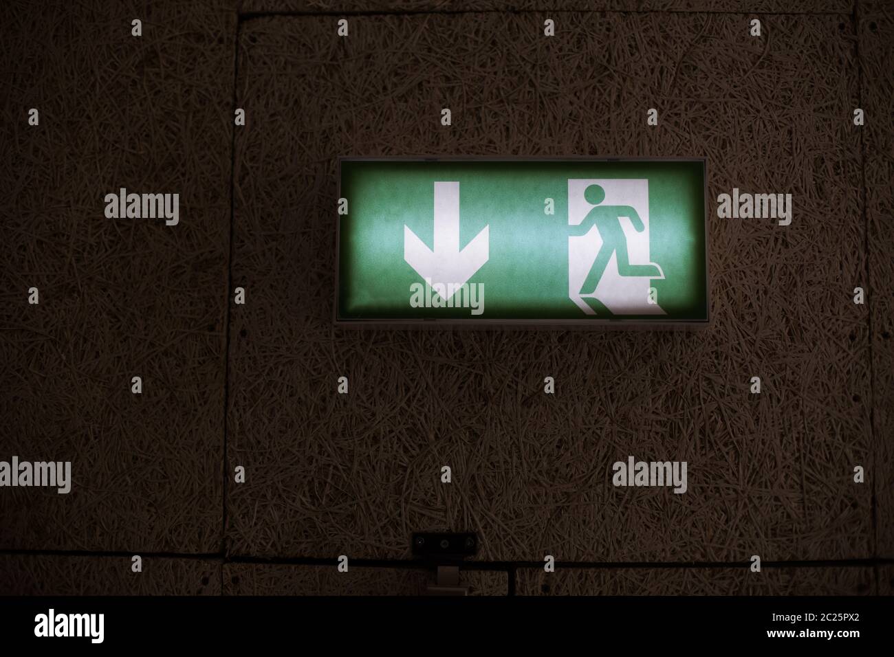 Color image of a green exit sign above a door Stock Photo - Alamy