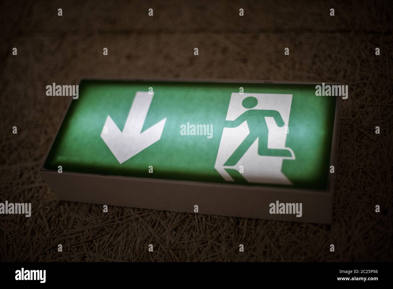 Color image of a green exit sign above a door Stock Photo - Alamy