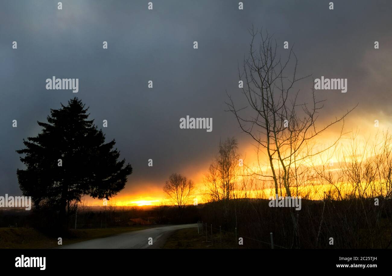 Evening sun on the way home over land Stock Photo - Alamy