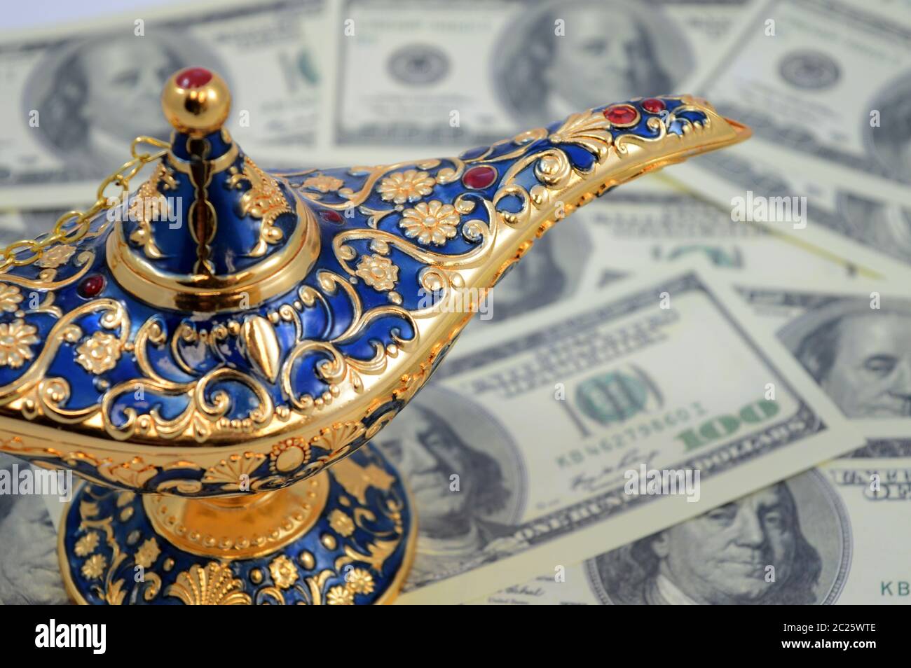 A magic genie lamp overtop of an abundance of American money for the ...