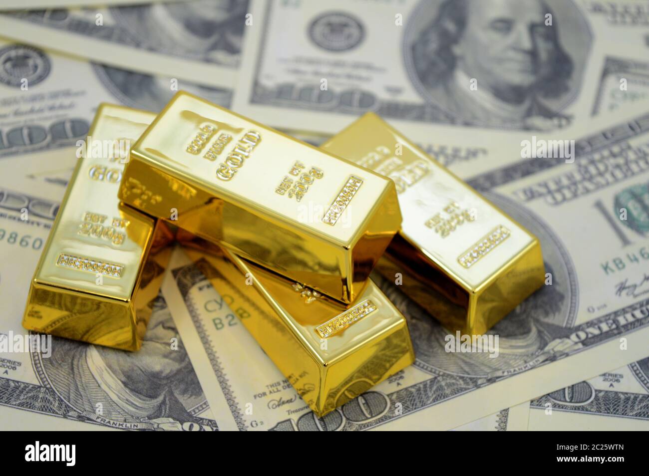 An abundance of solid gold bullion and American cash to represent the ...