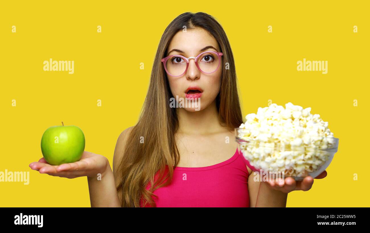 Undecided girl comparing food options having a hard time choosing ...