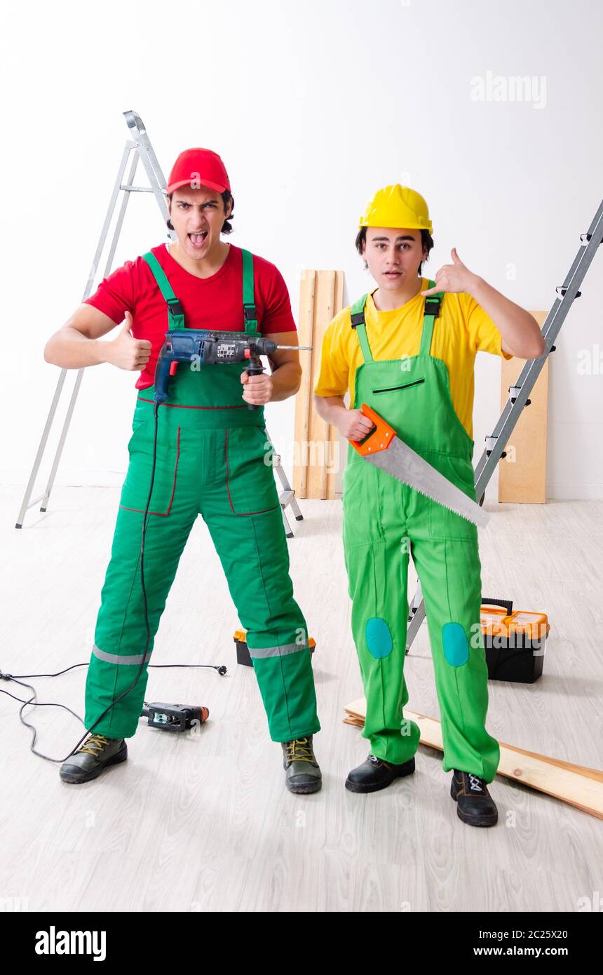 Two workers contractors working indoors Stock Photo - Alamy