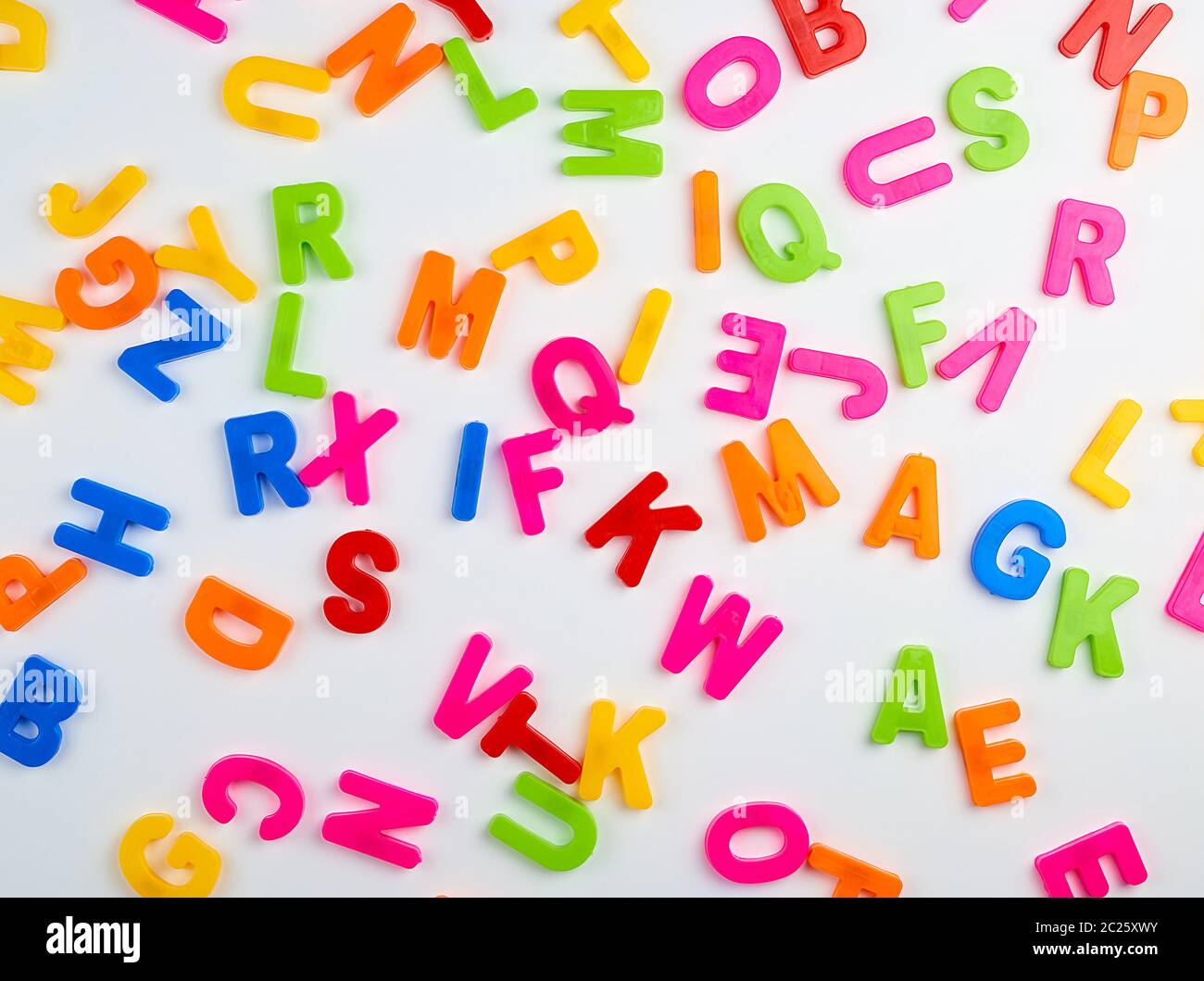 multicolored English alphabet letters on a white background, full frame ...
