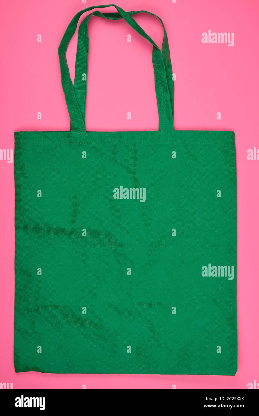 empty green ecological bag made of viscose with long handles, concept ...