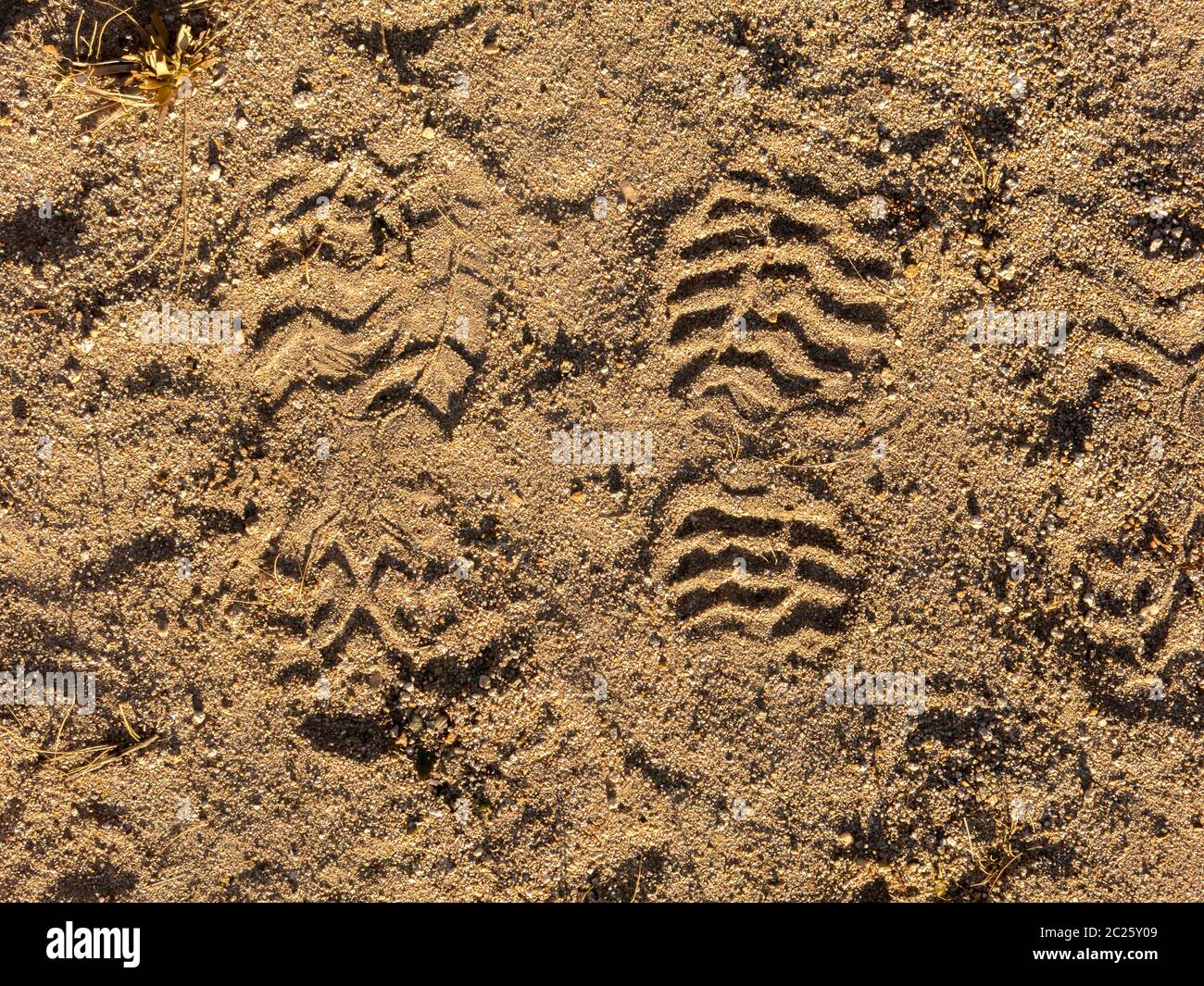 Two boots footsteps on sand Stock Photo - Alamy