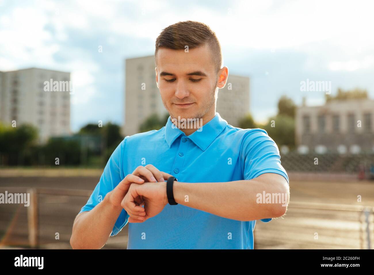 Sportsman, handsome man looking and checking his watch after running ...