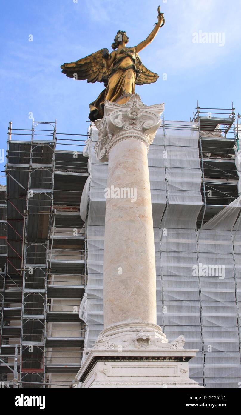 Winged Victory Woman Statue Holding Snake Golden Sculpture at Pillar in ...