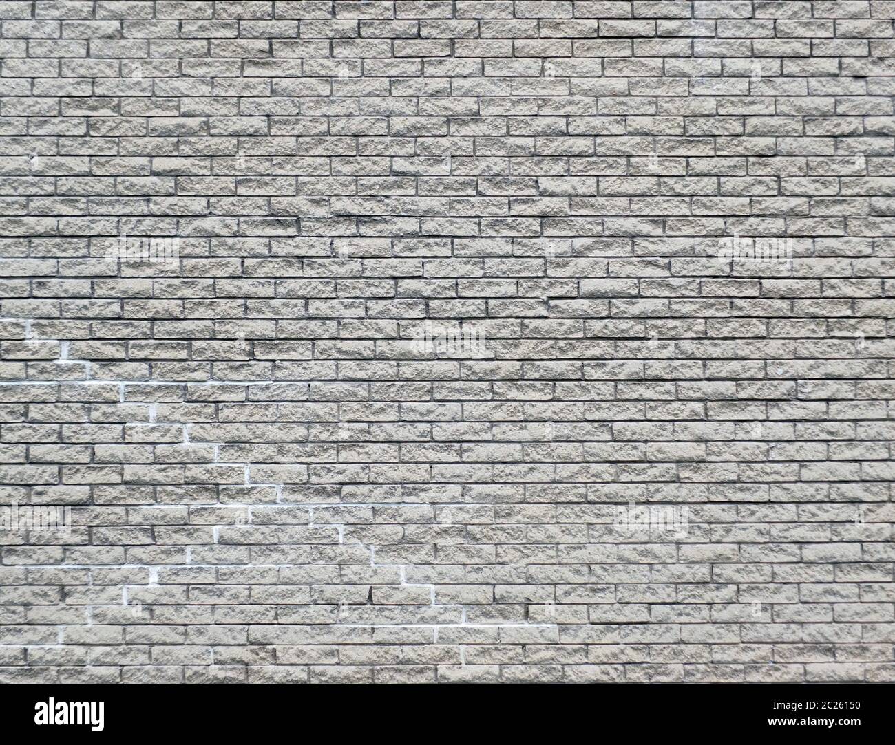 white brick wall background with cracks and repairs repeating pattern ...