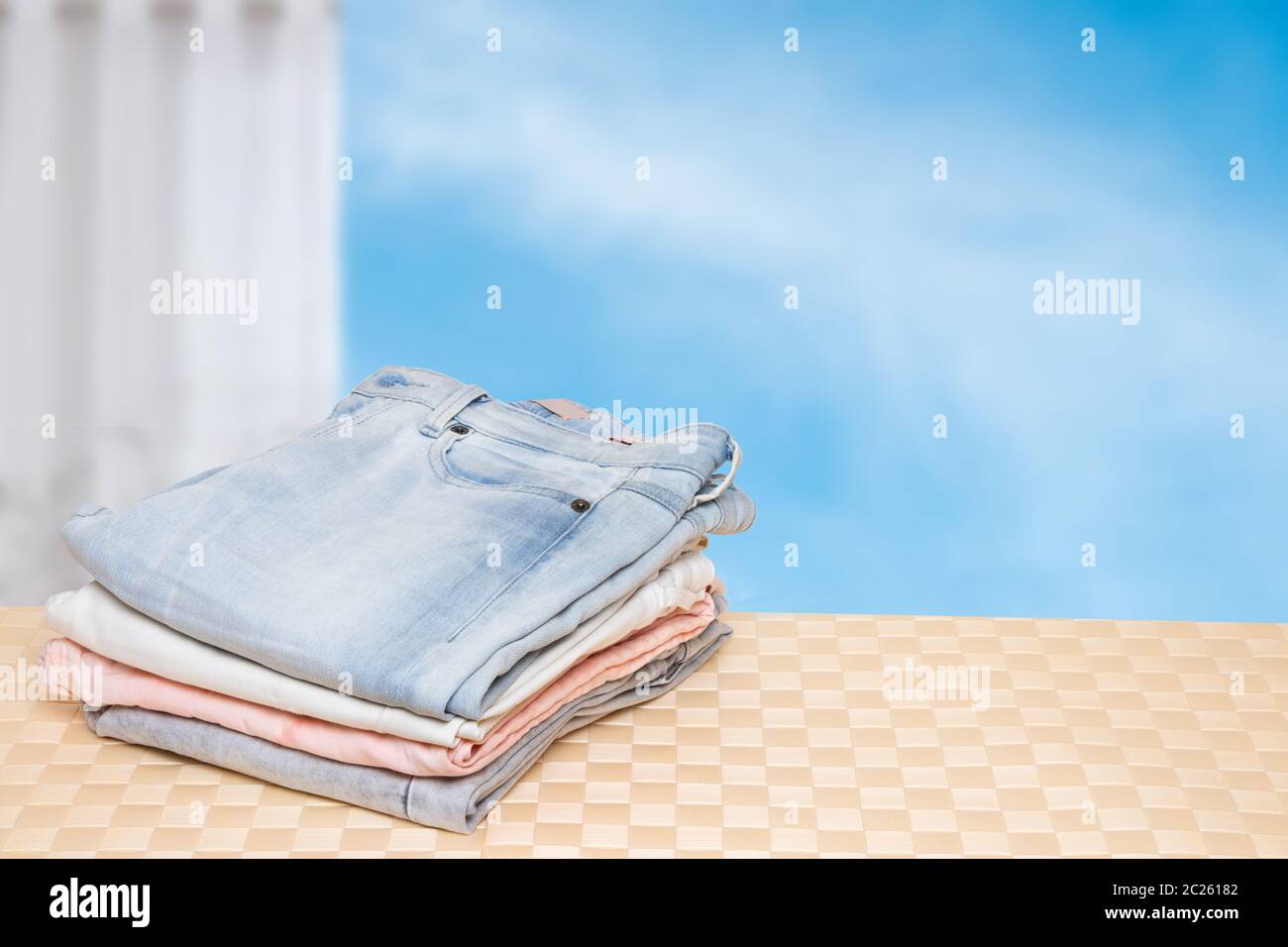 Stack of jeans. Closeup of a pile of colorful female denim pants on a ...