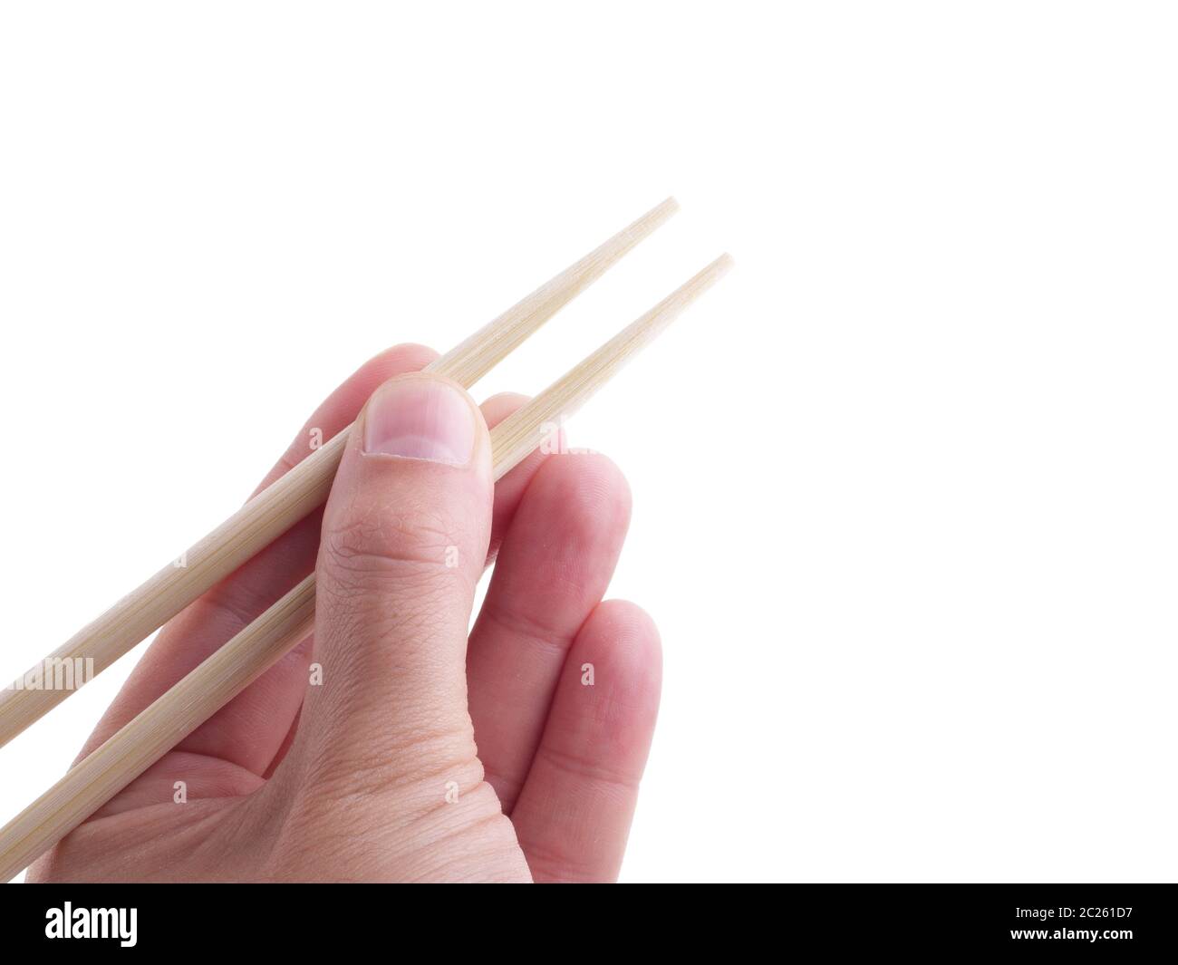 Male hands eating with asian wooden sticks isolated on white background ...