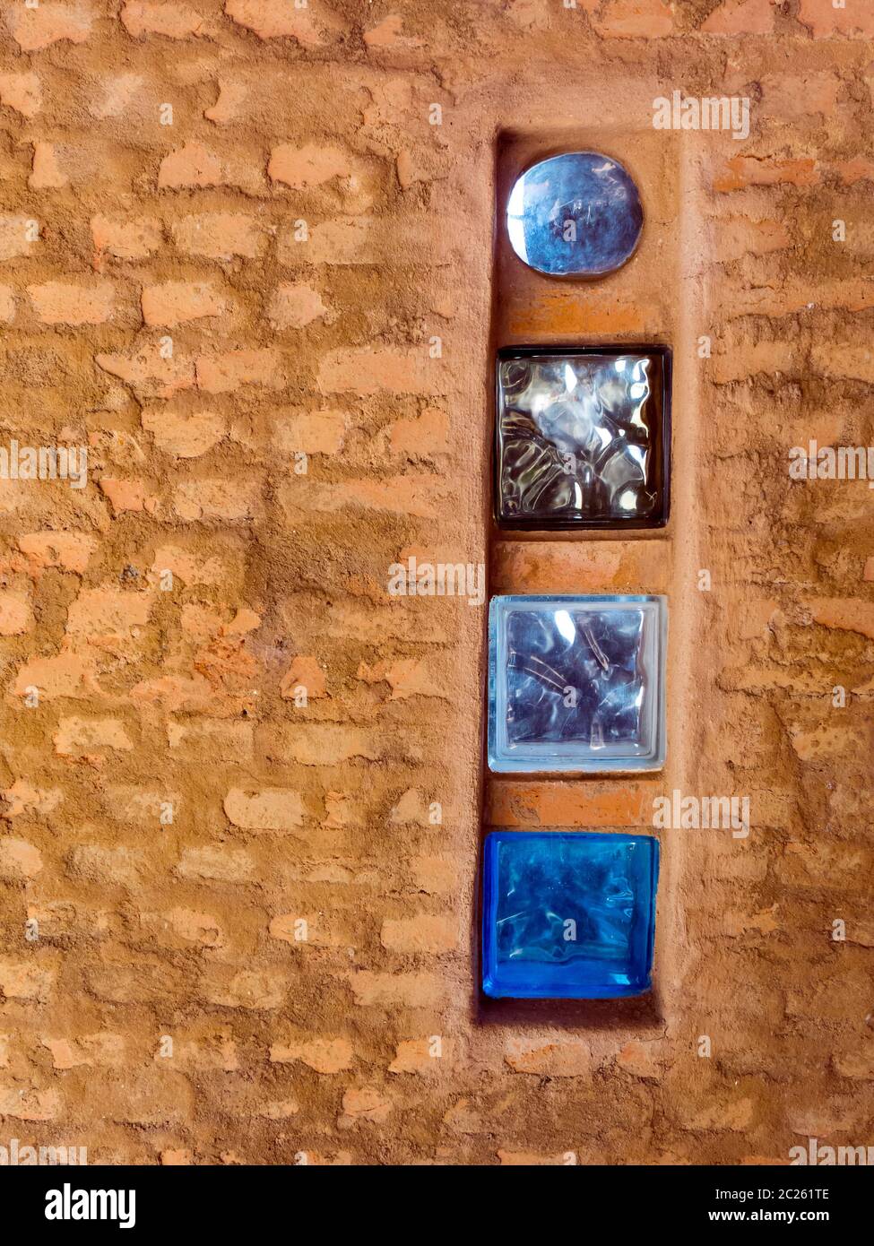 Brick wall with colored glass brick as windows in a rustic house Stock ...