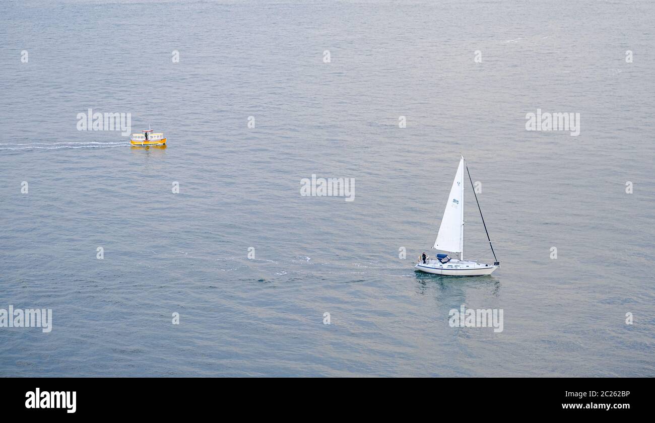 Large Sailboat and Small Yellow Boat Stock Photo - Alamy