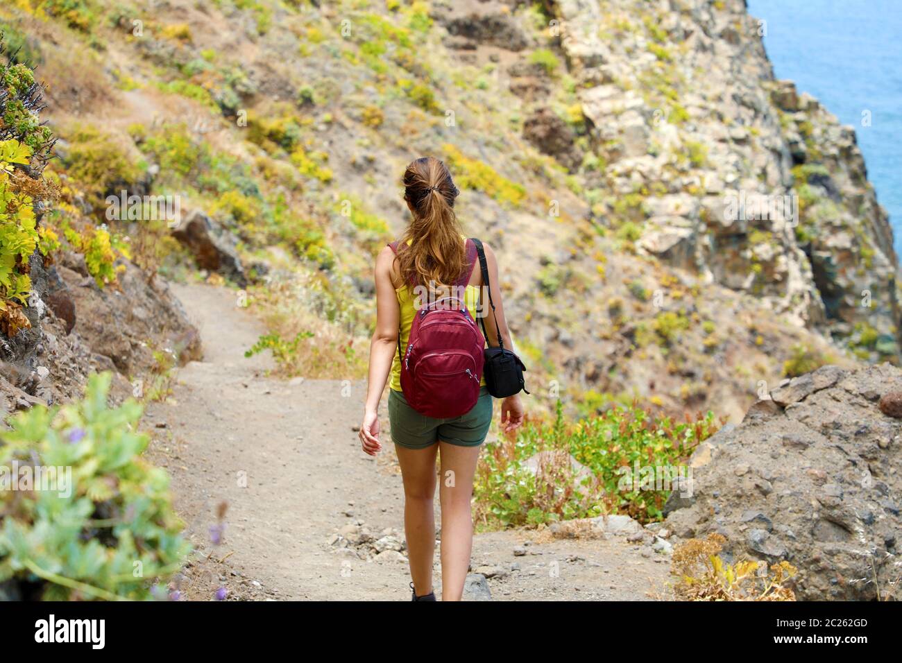 Young hiker woman back view walking on mountain path Stock Photo - Alamy