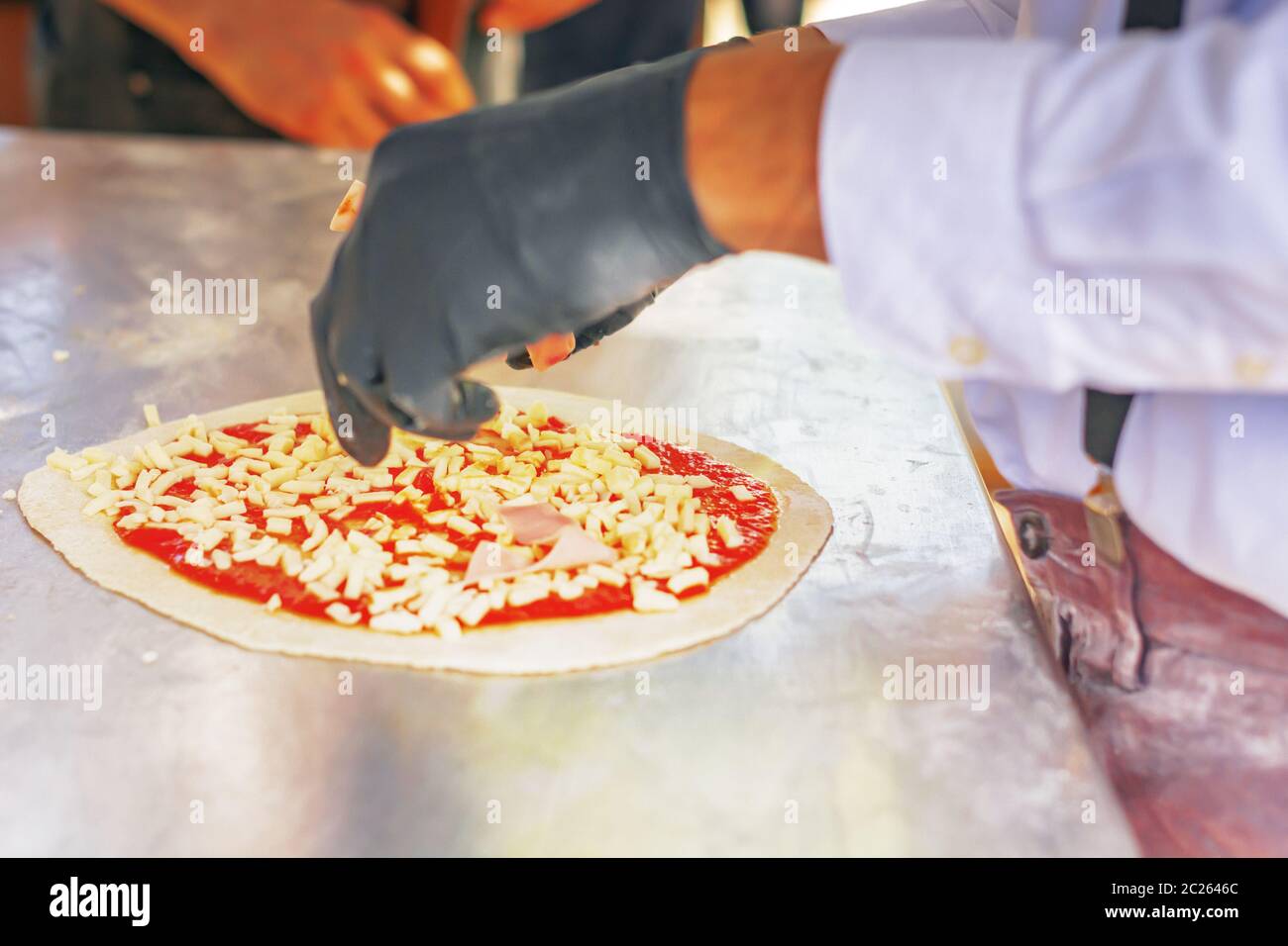 Pizza maker preparing a pizza Stock Photo - Alamy