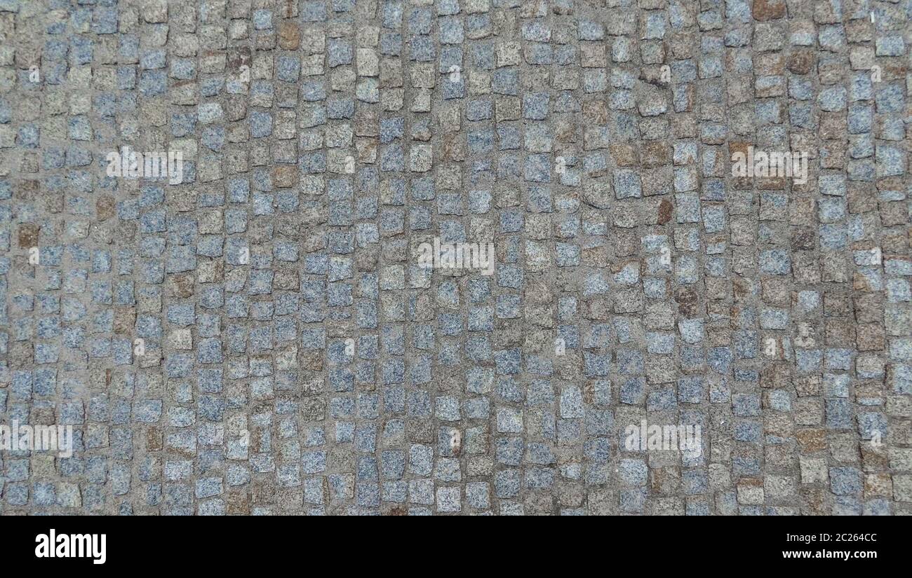 Texture of broken cobblestone road in europe Stock Photo - Alamy