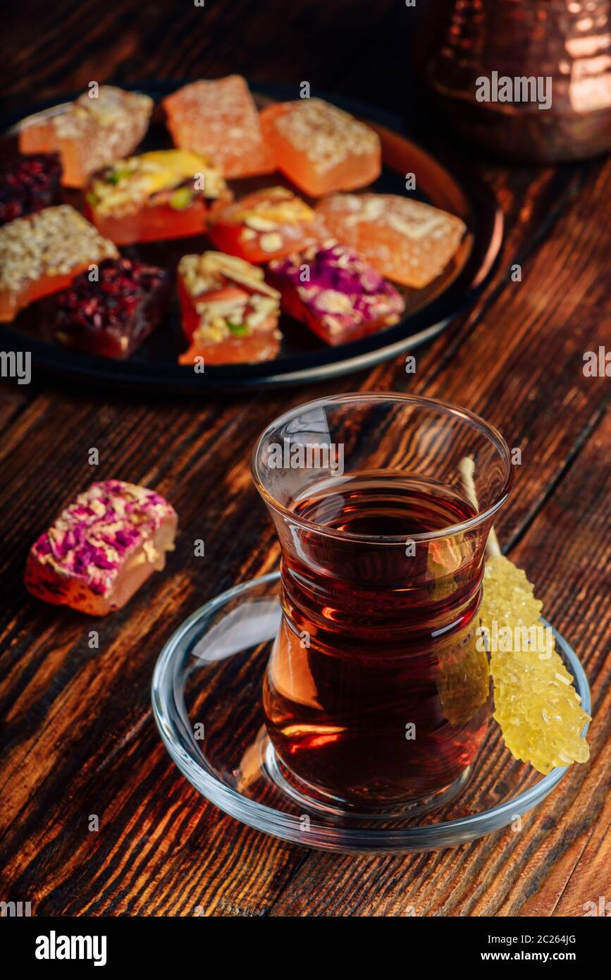 Tea in armudu glass with oriental delight rahat lokum over wooden ...