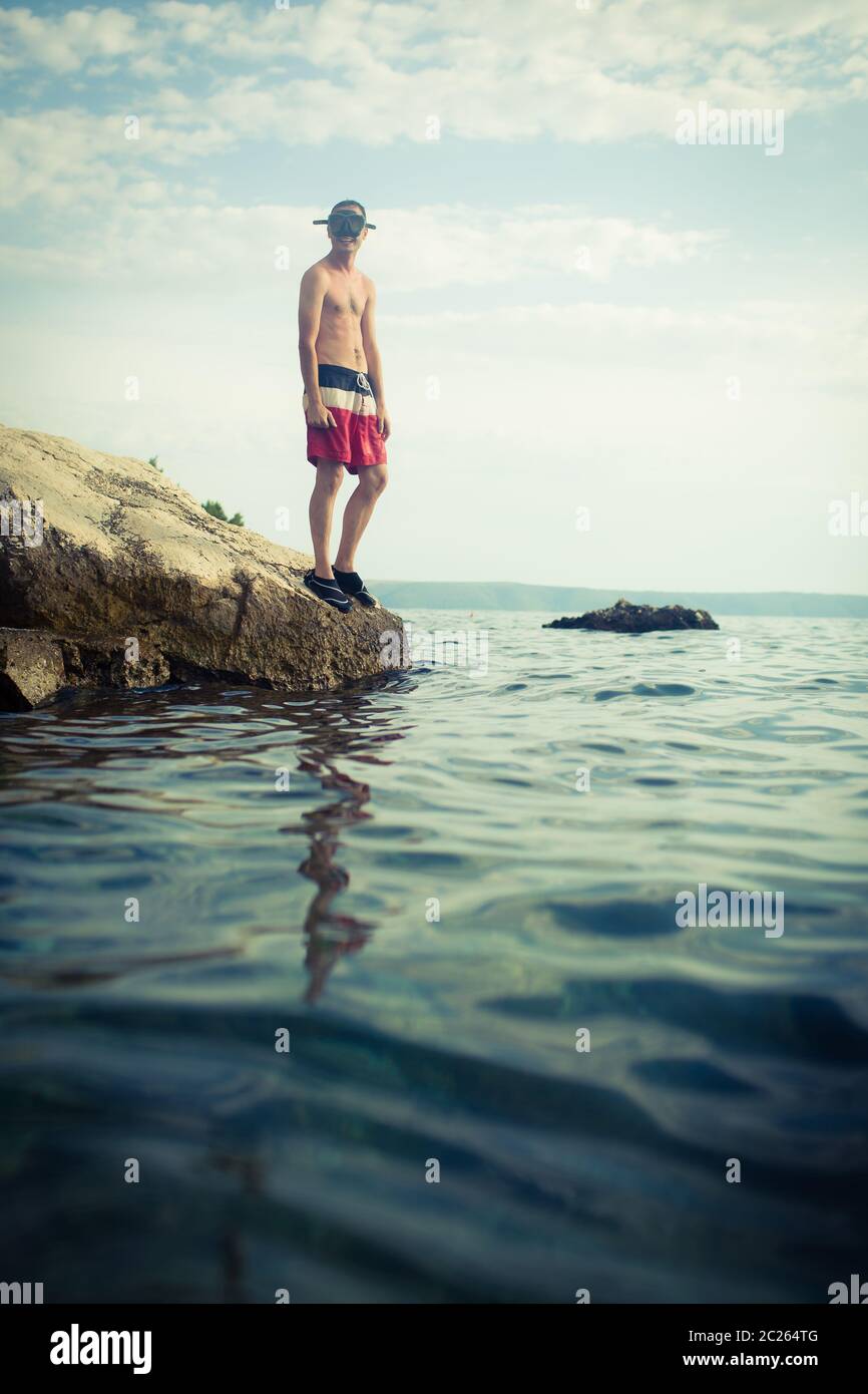 Young man having fun and taking a dive in the sea Stock Photo - Alamy
