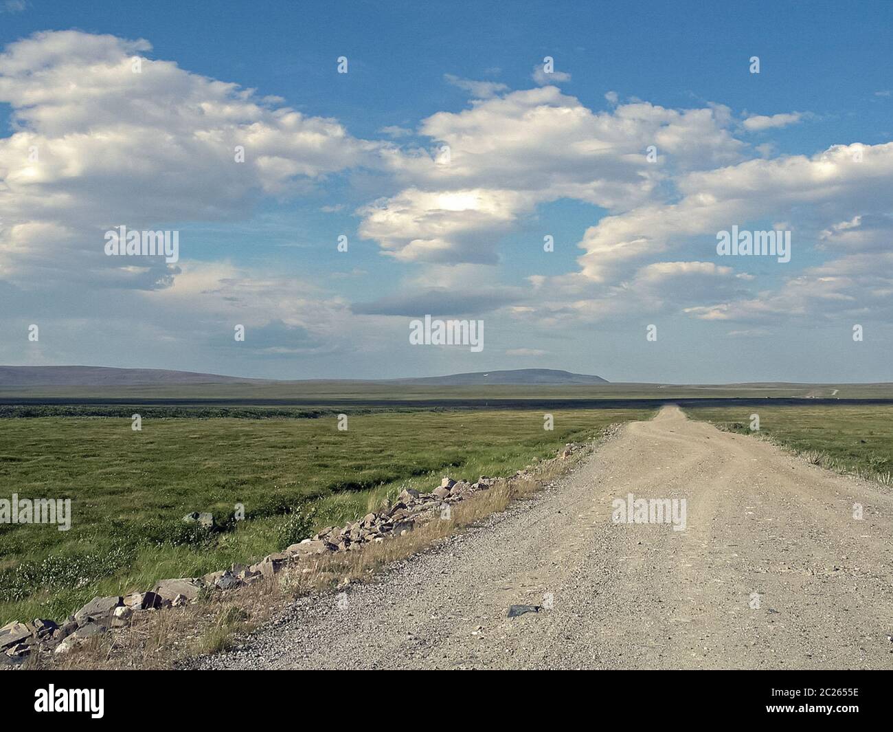 A dirt road in the tundra in the summer. The road from the rubble mound ...