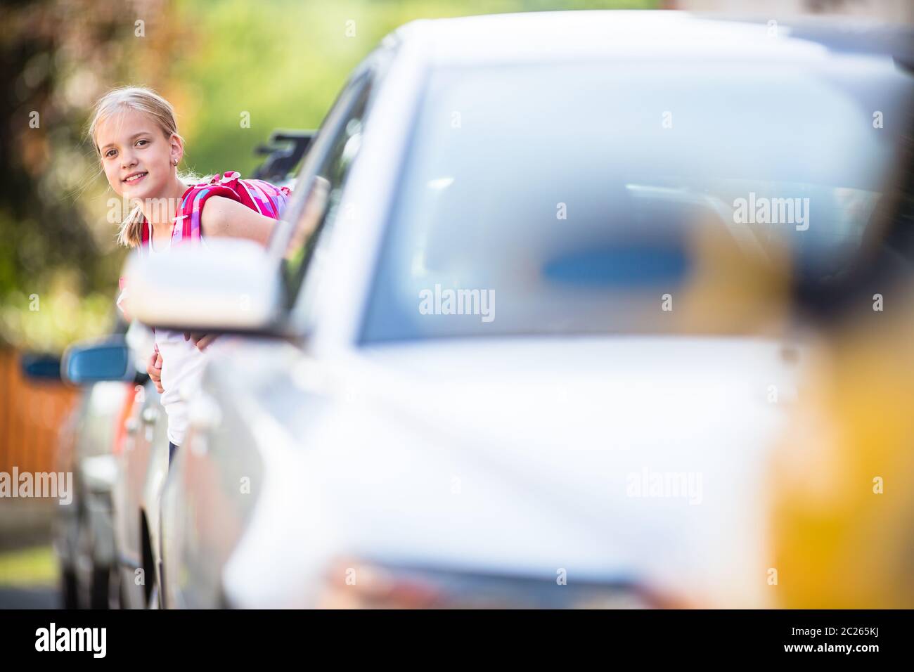 Cute little girl going home from school, looking well before crossing ...