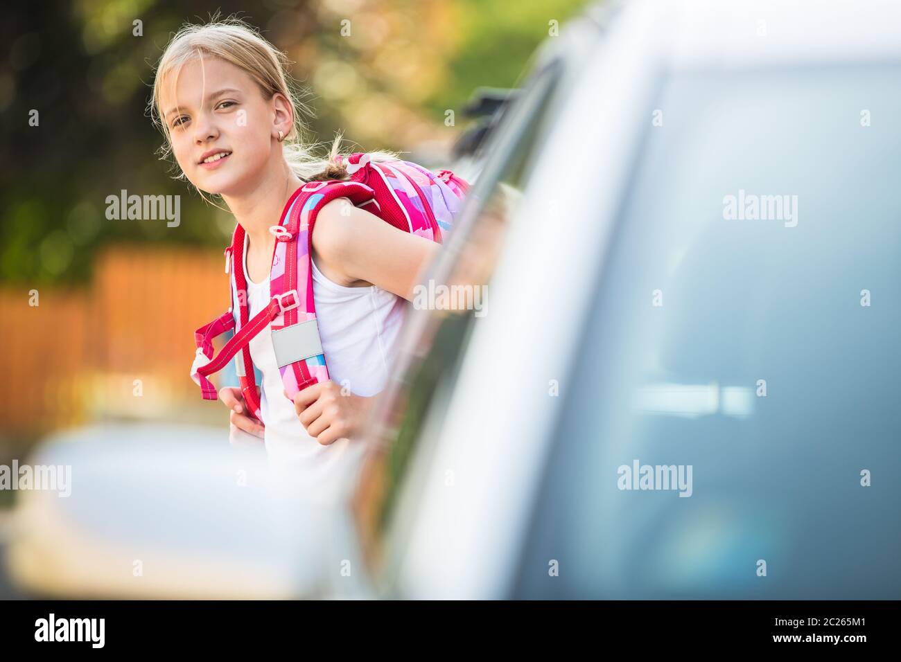 Cute little girl going home from school, looking well before crossing ...