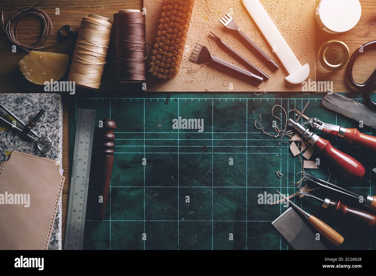 flat lay of leather working tools on wooden desk Stock Photo - Alamy