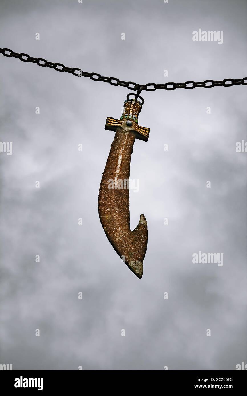 Old rusty sword hanging on a chain Stock Photo - Alamy