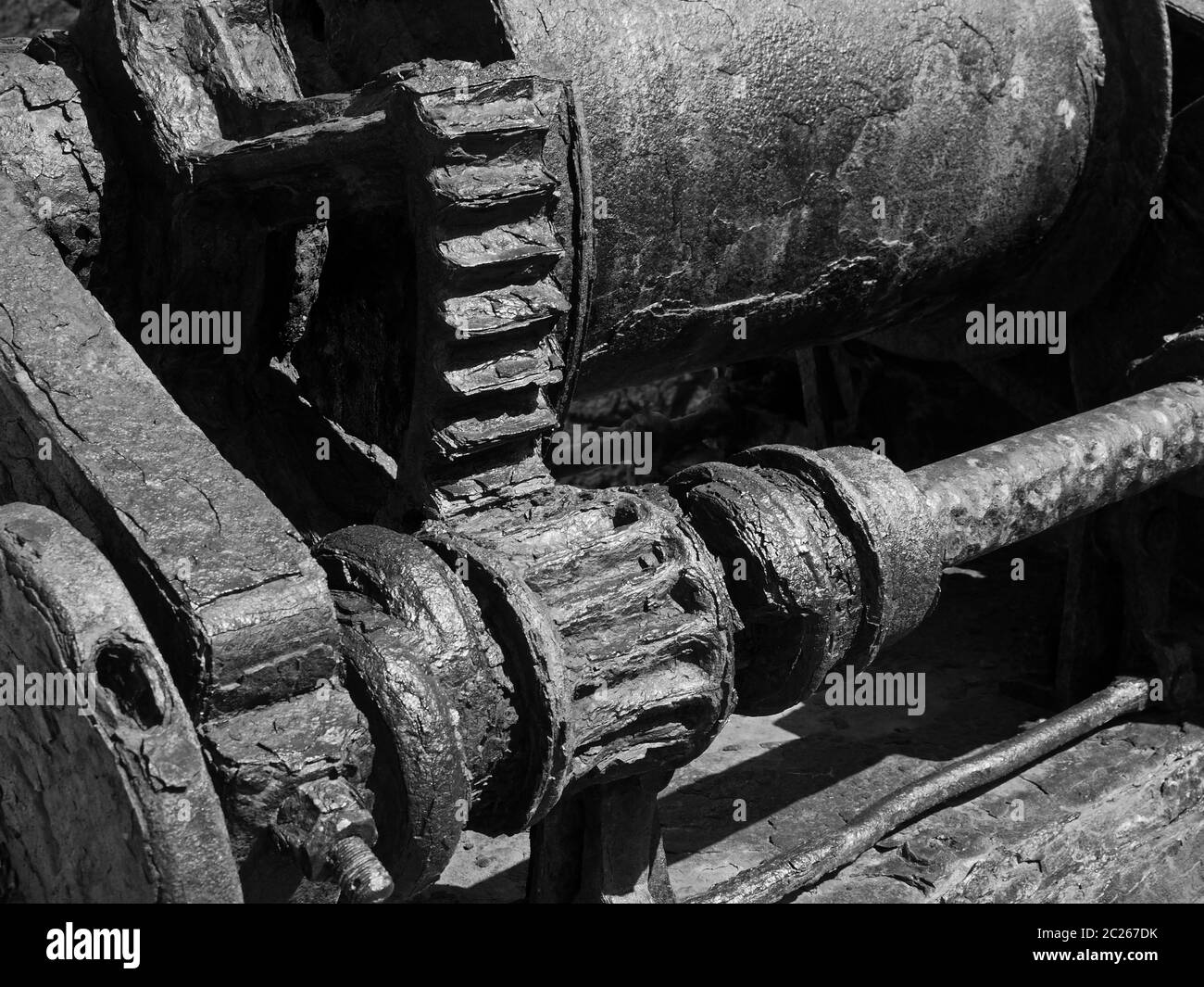 monochrome image of old rusted machinery with corroded cogs and gears ...