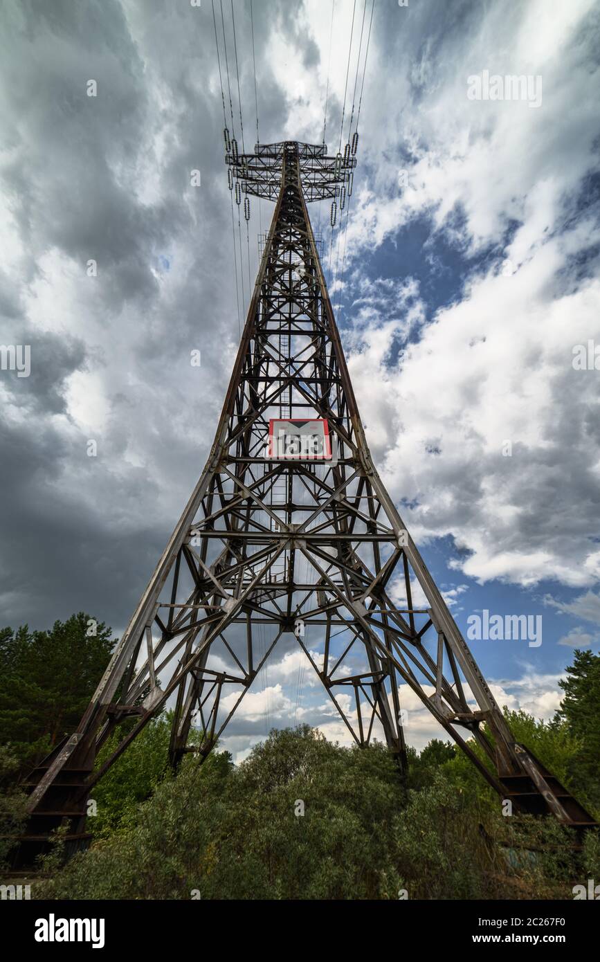 power line mast against blue sky with white clouds, close-up Stock ...