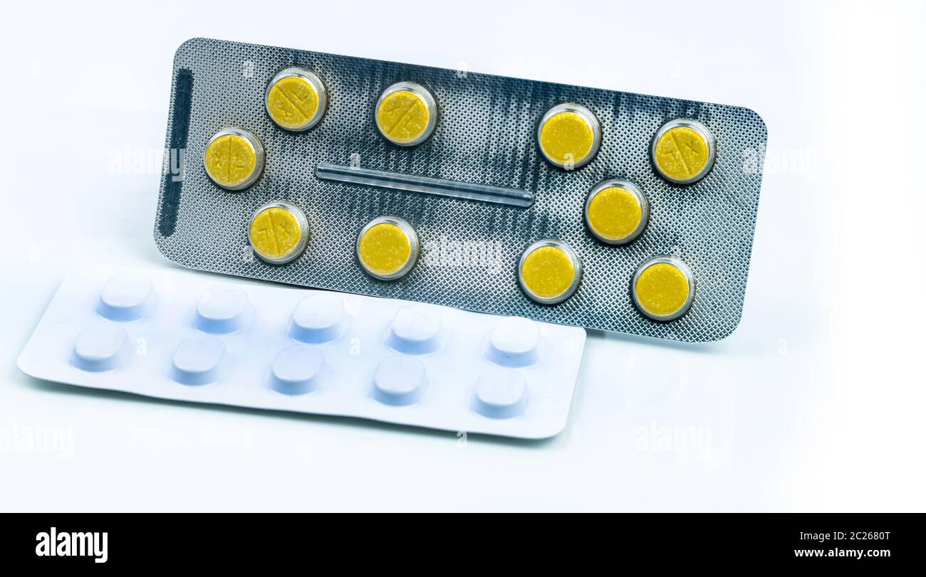 Ergotamine drug interactions concept. Yellow tablet pills and white ...