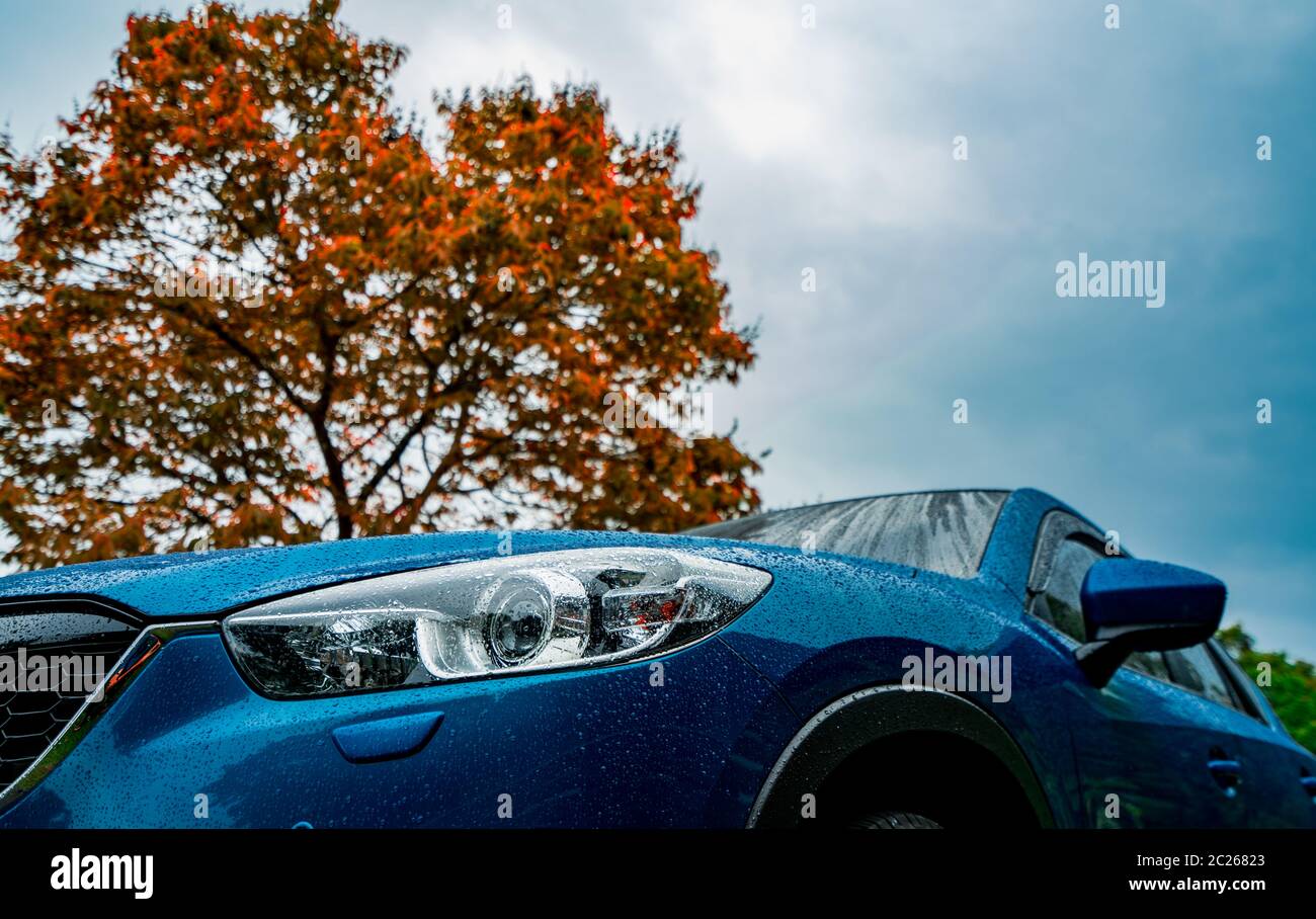 Blue compact SUV car with sport and modern design parked near red ...