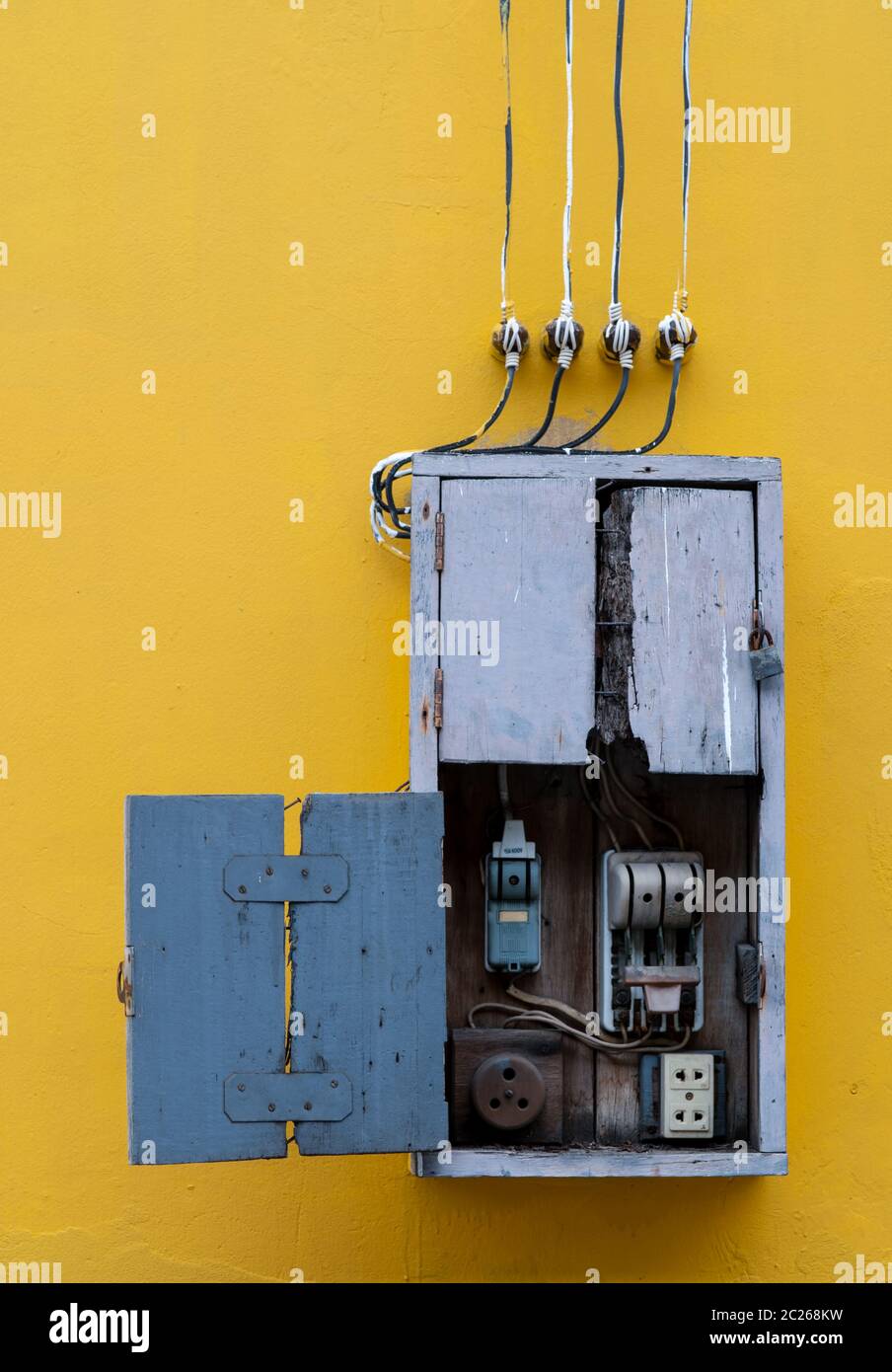 Wooden box, electric control equipment in the factory on yellow vintage ...