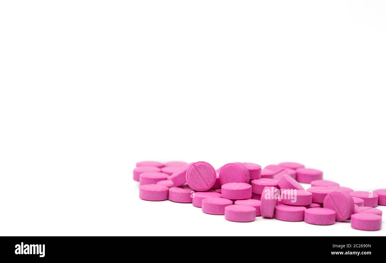 Pile of warfarin pink tablet pills on white background. Warfarin for ...