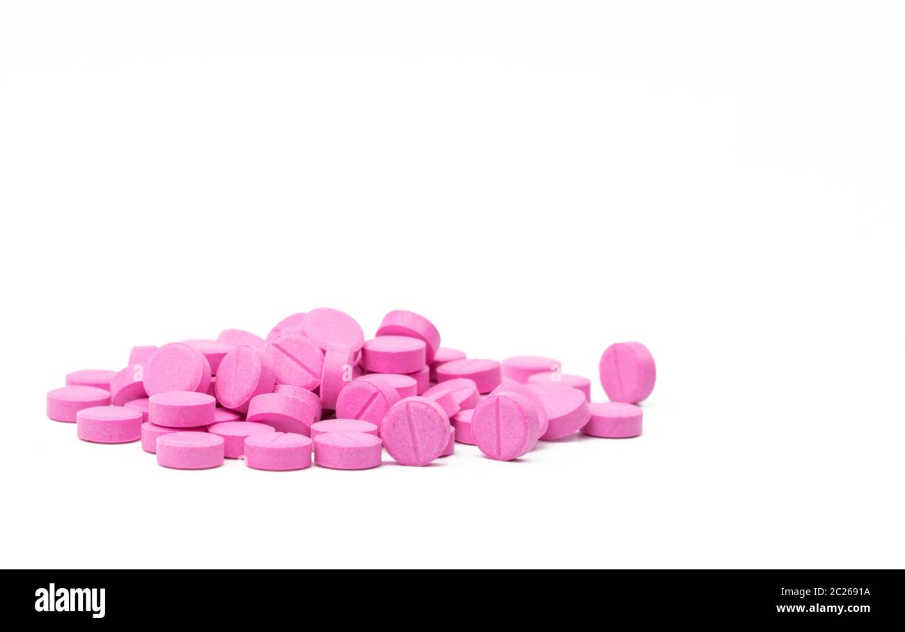 Pile of warfarin pink tablet pills on white background. Warfarin for ...