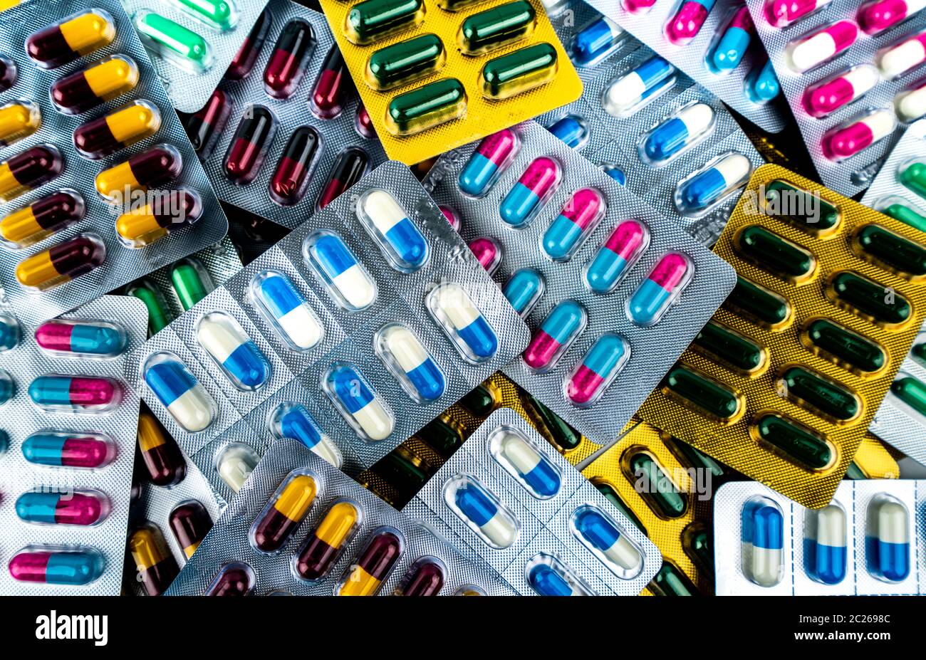 Pile of antibiotic capsule pills in blister packs. Medicine for ...