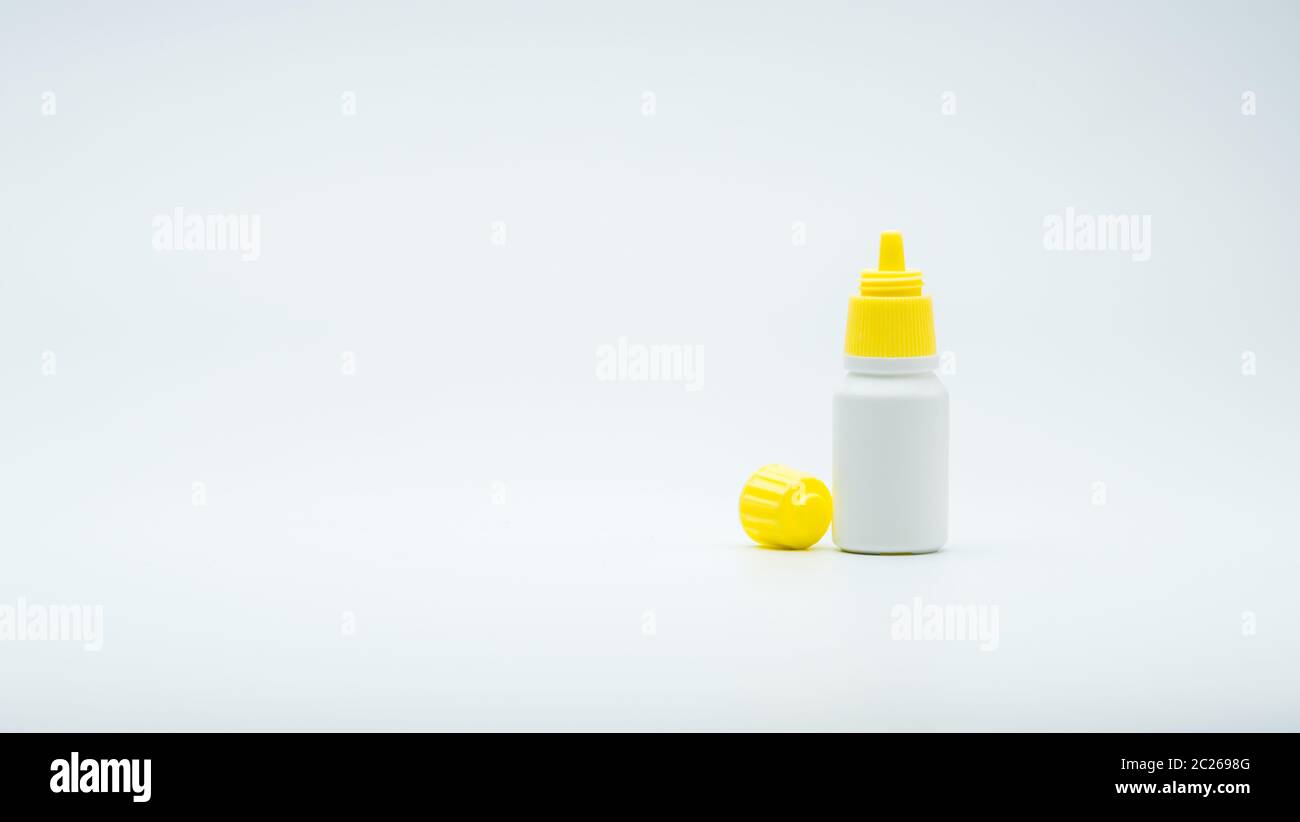Eye drops bottle with open yellow cap isolated on white background with ...