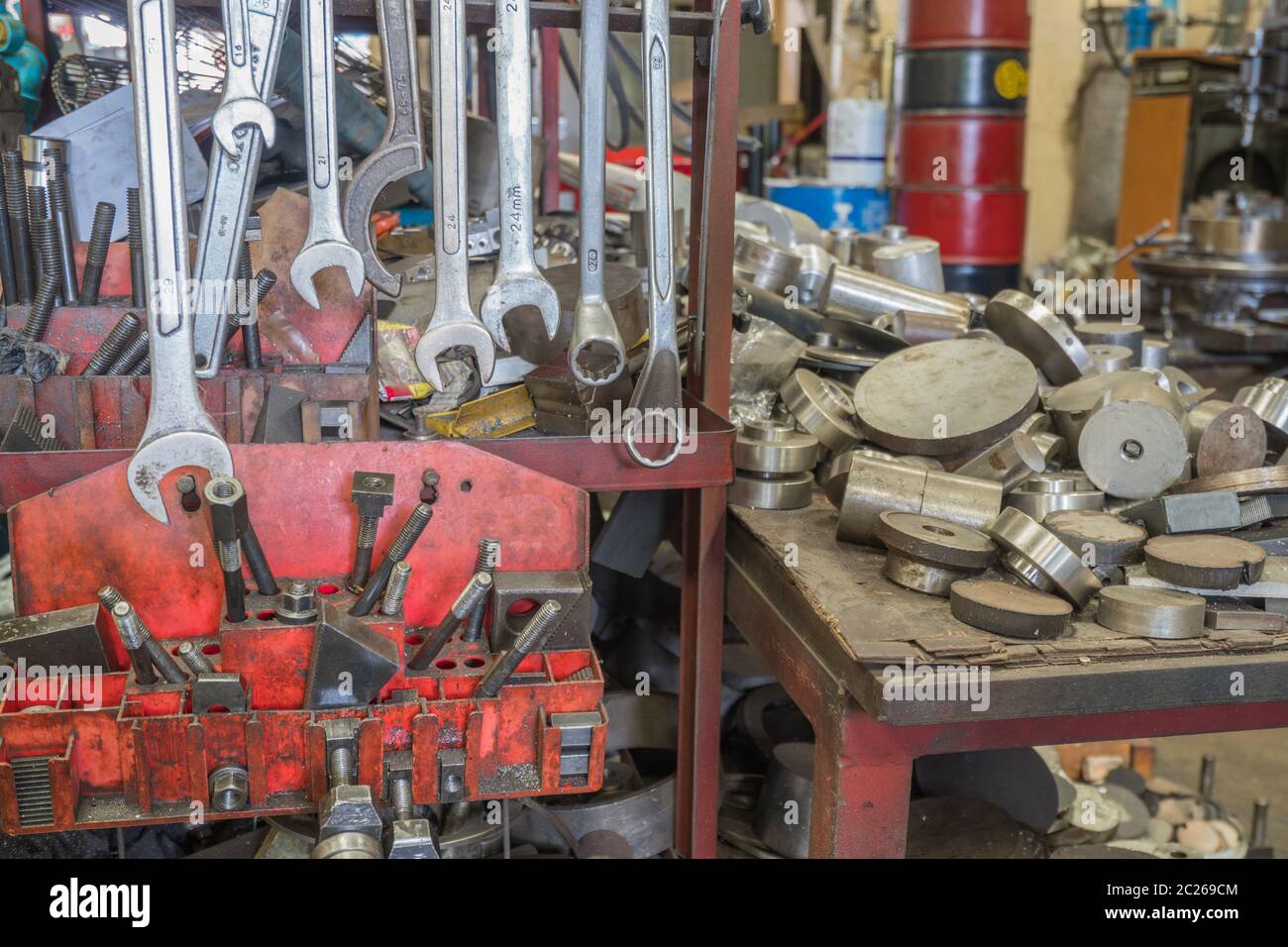 Many of spanner hang on metal hanger, untidy tools at the background ...
