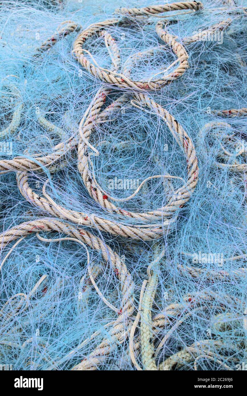 Background made from blue fishing nets and ropes Stock Photo - Alamy