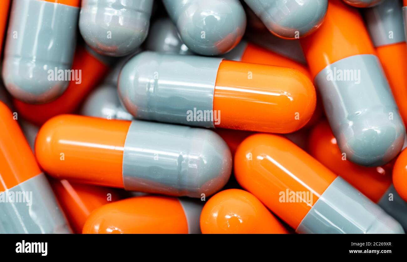 Top view of orange and grey capsule pills. Pharmaceutical industry ...