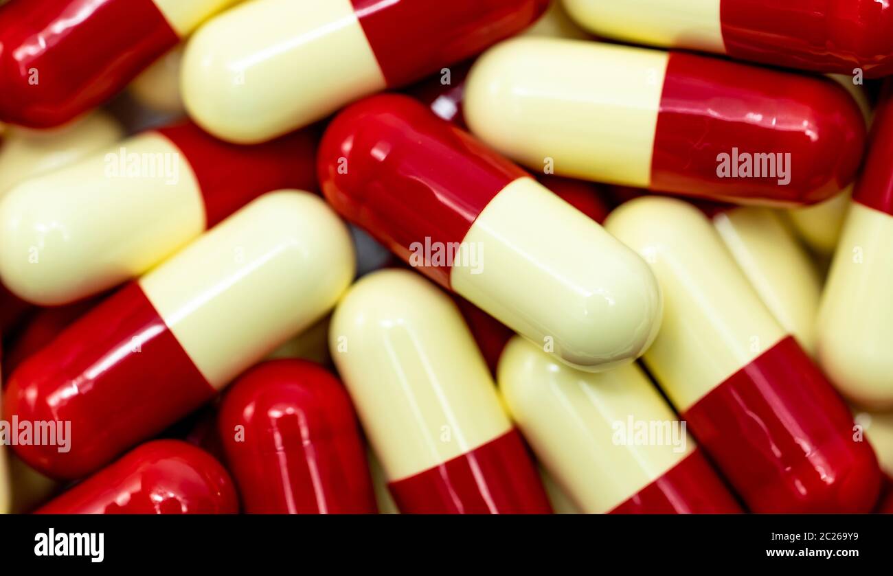 Top view of red and yellow capsule pills. Pharmaceutical industry ...