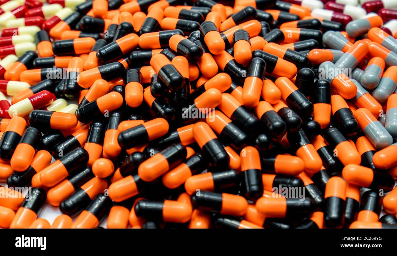 Pile of colorful antibiotic capsule pills. Pharmaceutical industry ...