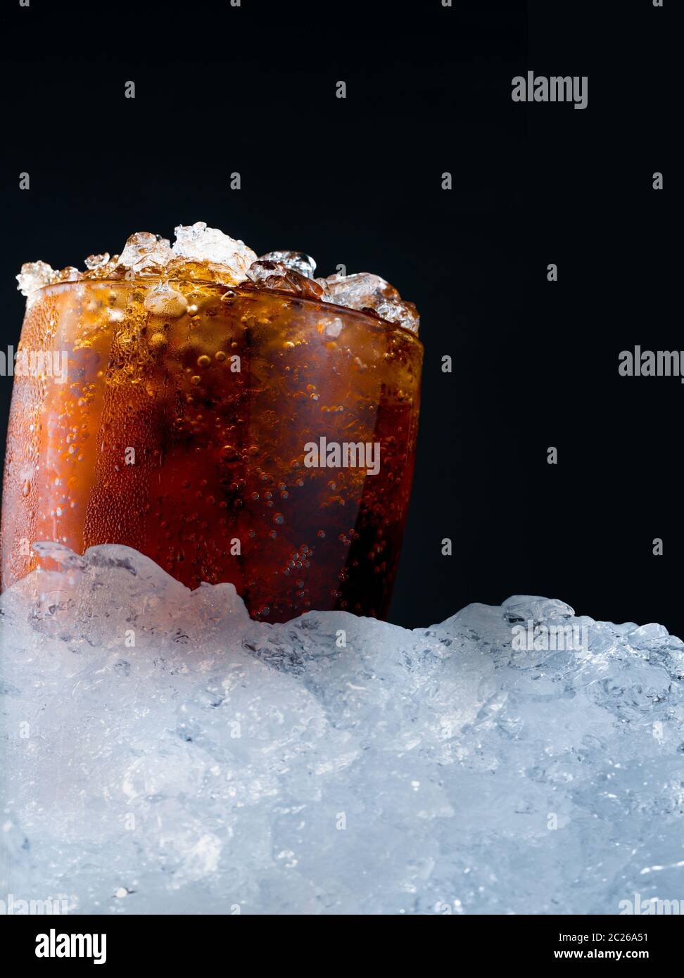Soft drink with crushed ice cubes in glass put on pile of ice cubes on ...