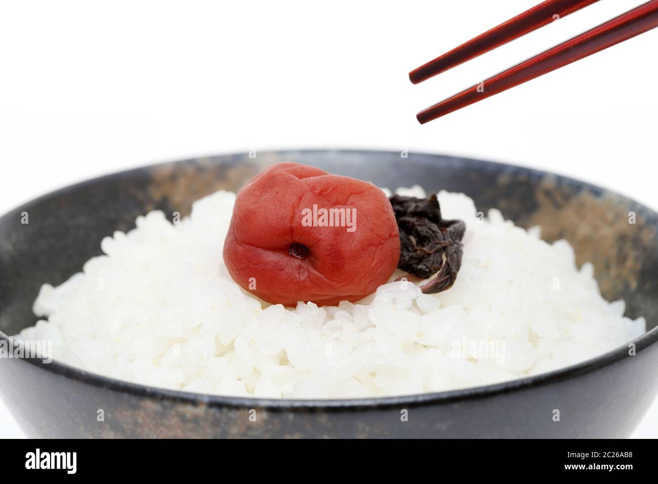 Japanese cooked white rice with salt plum on white background Stock ...