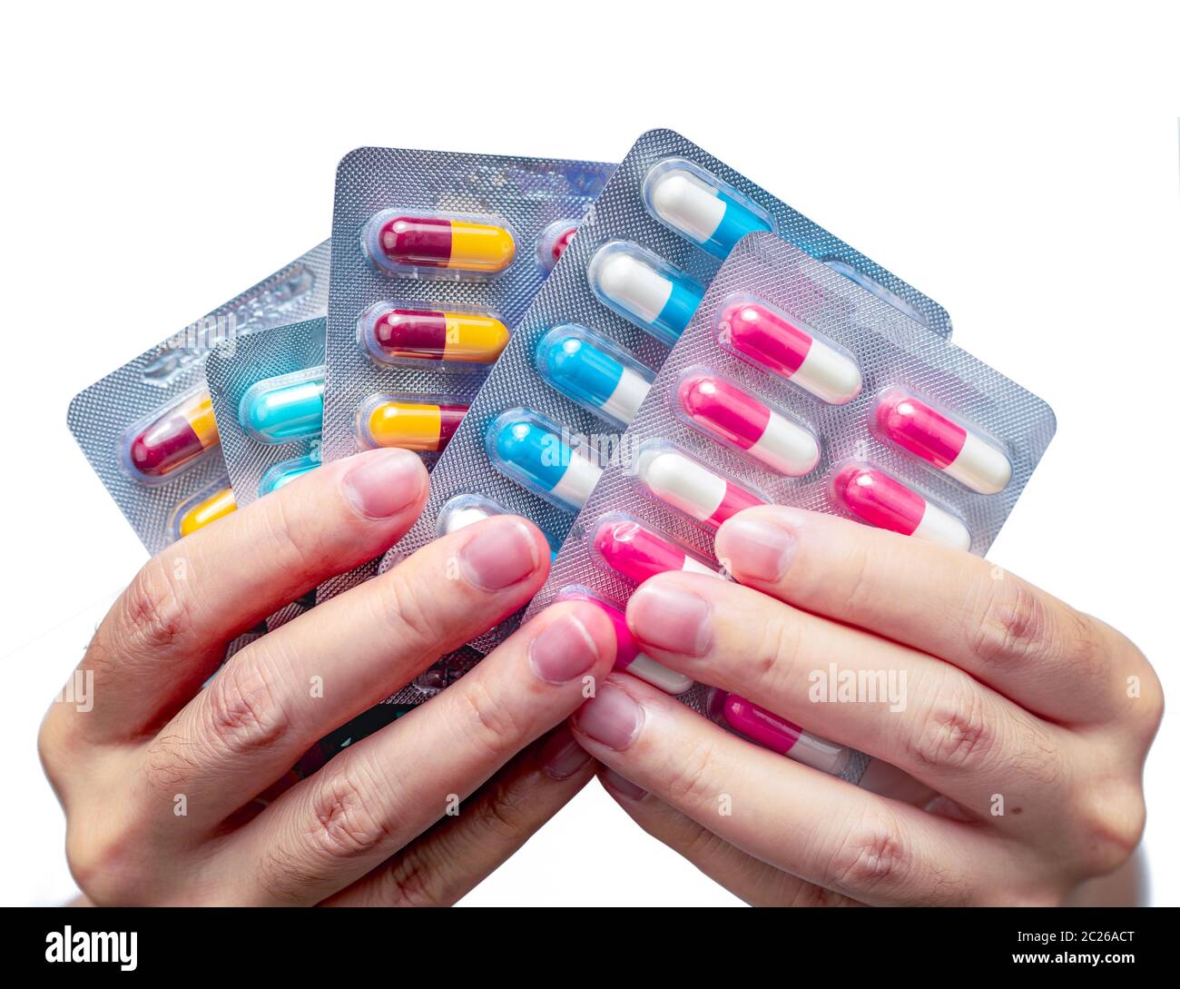 Woman hand holding pack of antibiotic capsule pills isolated on white ...