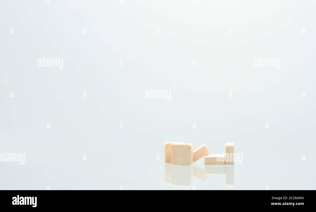 Five orange square tablets pills isolated on white background with ...