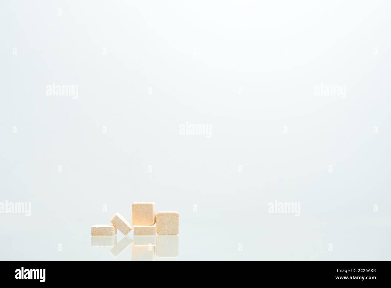 Five orange square tablets pills isolated on white background with ...