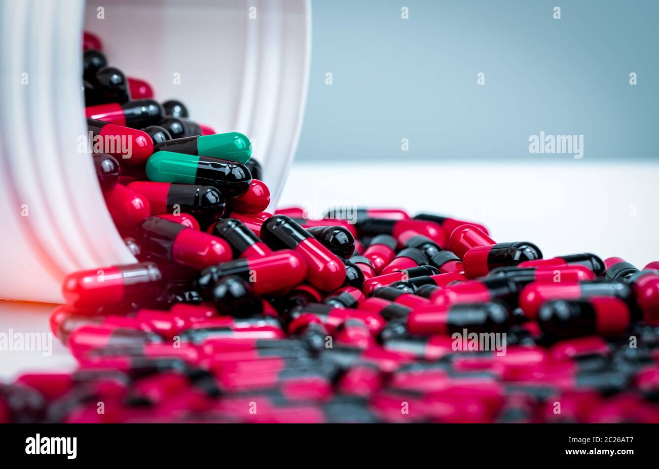 Capsules pill spilled out from white plastic bottle container ...