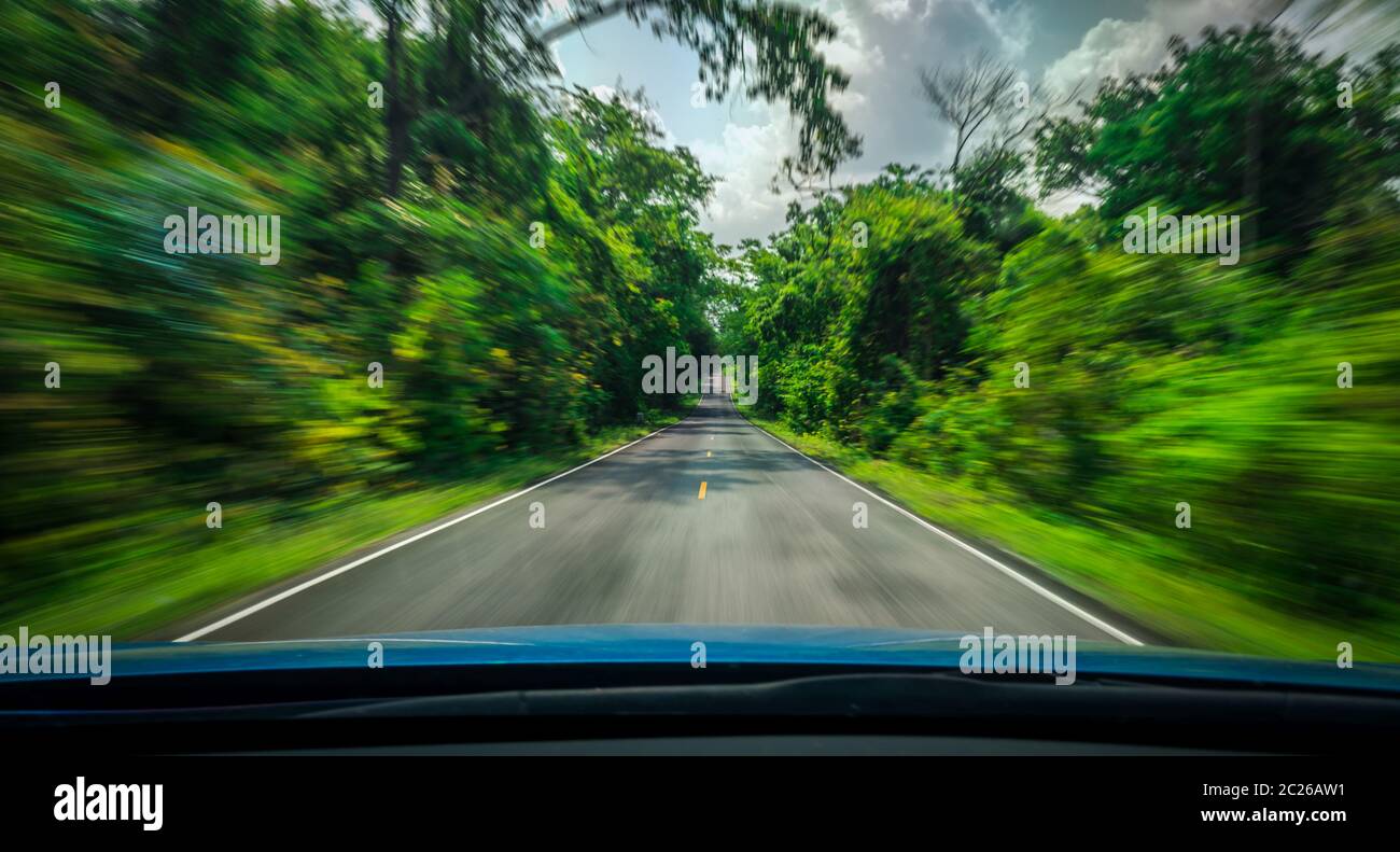 View from front of blue car on asphalt road and speed motion blur on ...