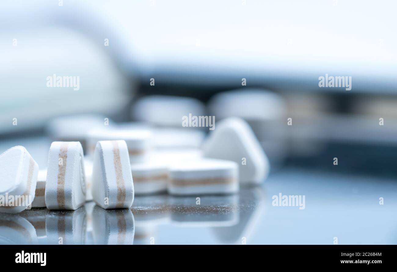 Macro shot of triangle shape tablet pills. Three layers tablet pills ...
