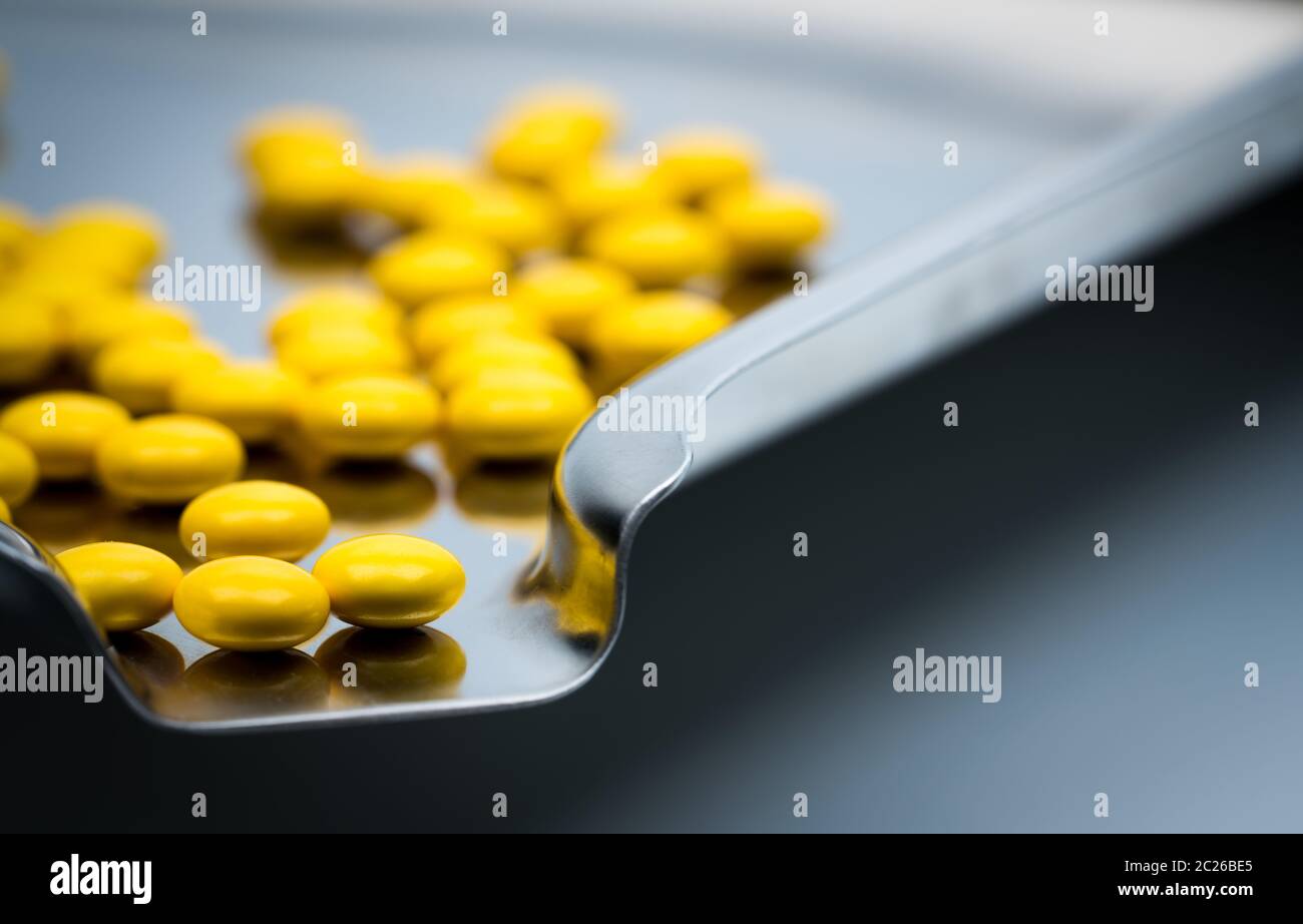 Macro shot detail of yellow round sugar coated tablets pills on ...